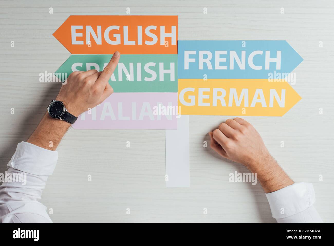 cropped view of translator pointing at arrows with languages Stock ...