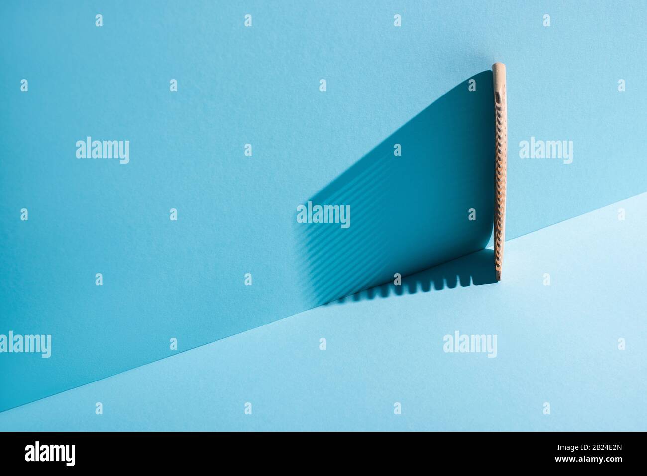 Comb with shadow on blue background, zero waste concept Stock Photo - Alamy
