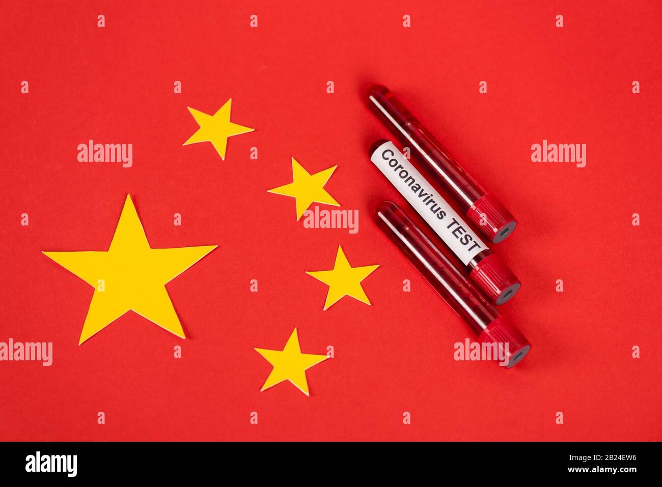 top view of samples with coronavirus test lettering near red chinese ...