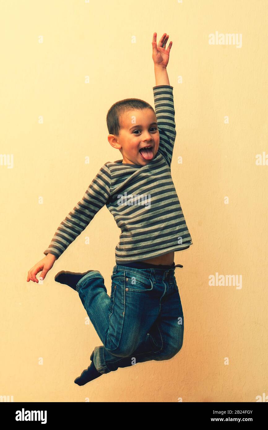 boy laying in the house. children playing at home. jumping children ...