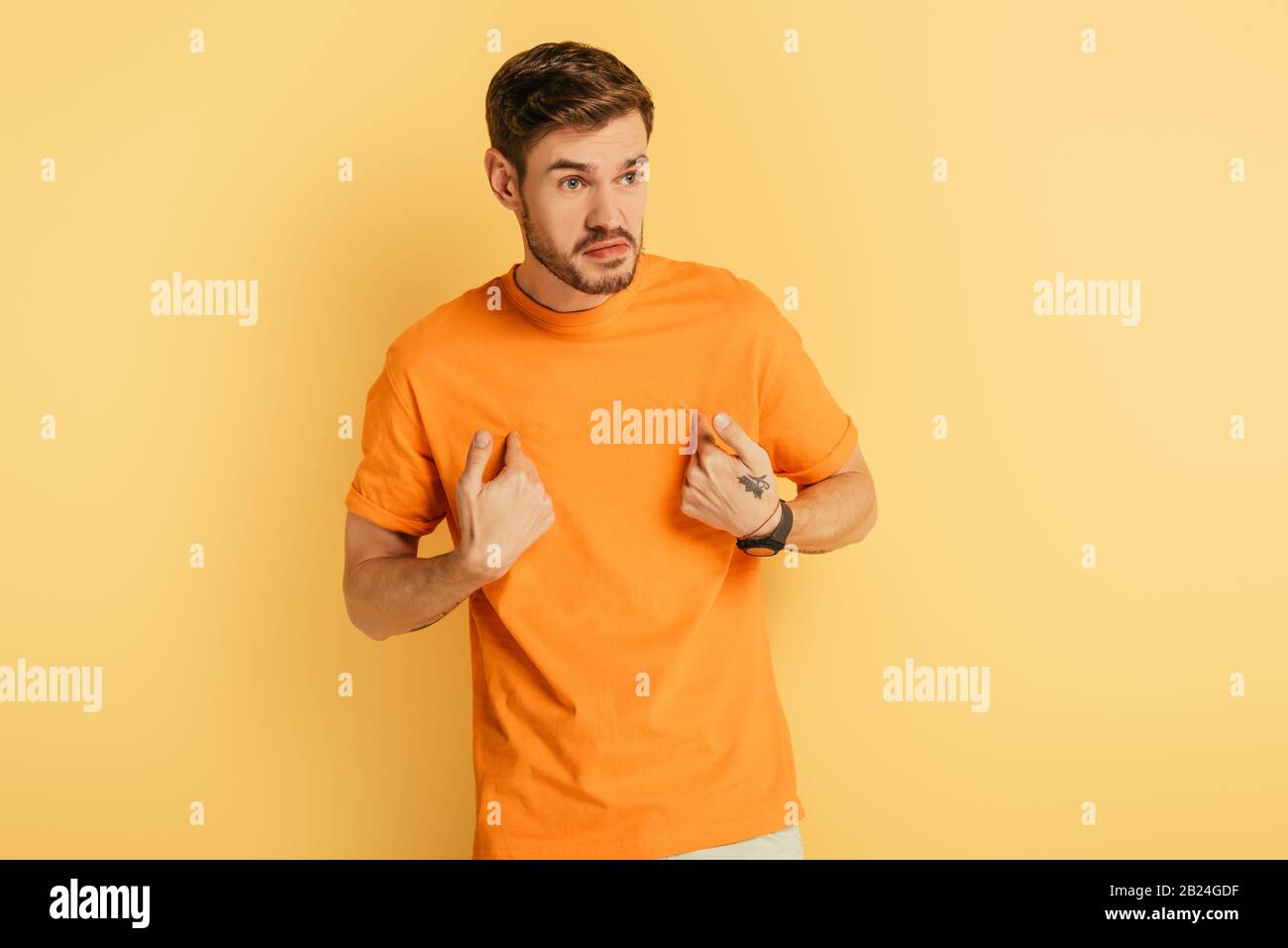 angry young man point with himself with fingers while looking away on ...