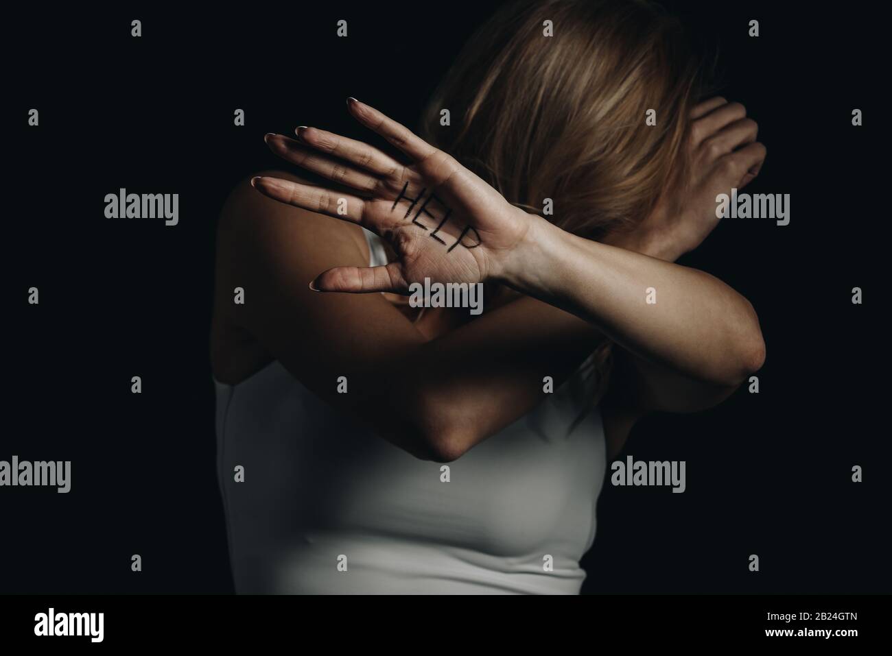 Victim hiding and showing palm with help lettering isolated on black ...