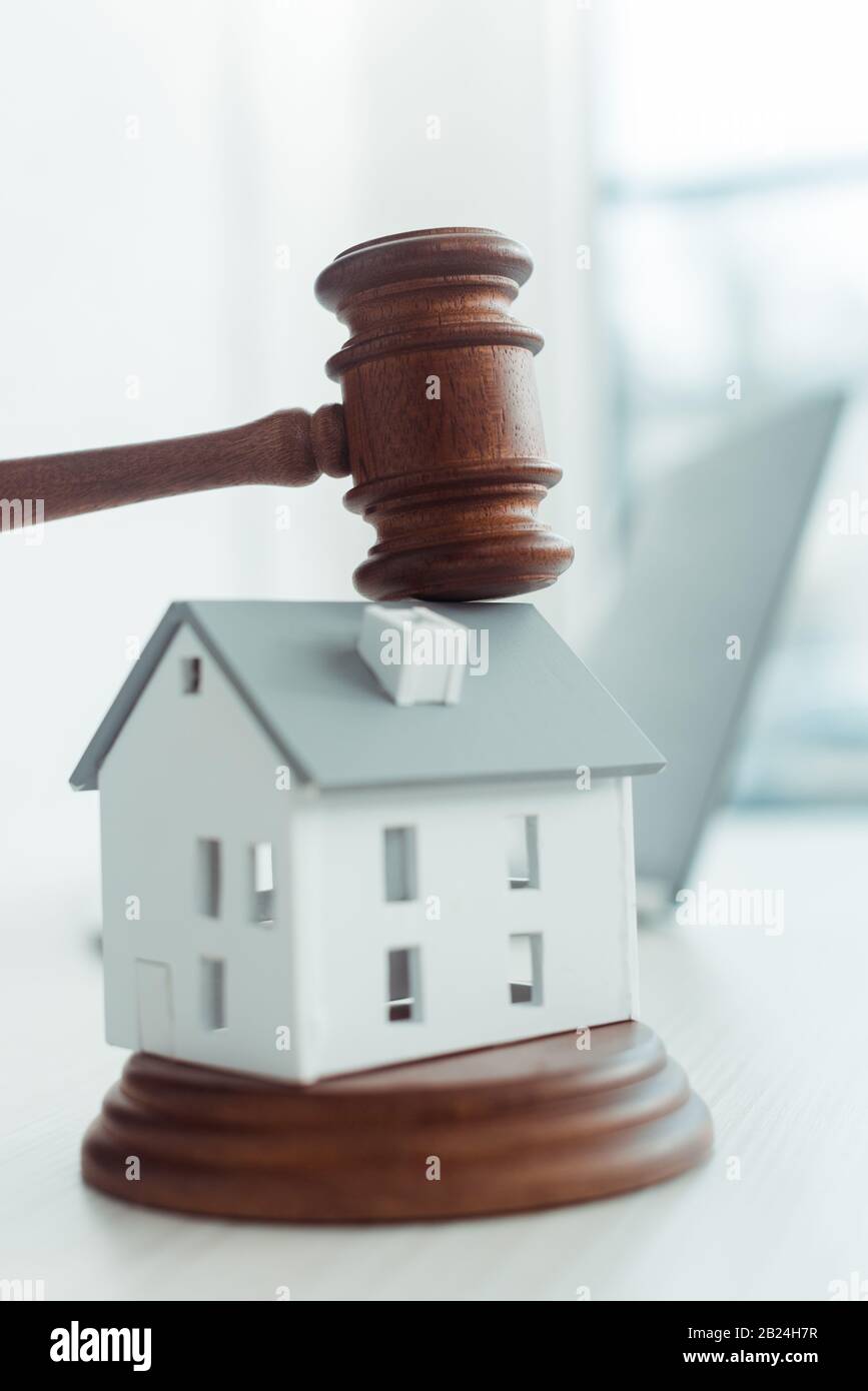 wooden gavel and model of house on table Stock Photo - Alamy