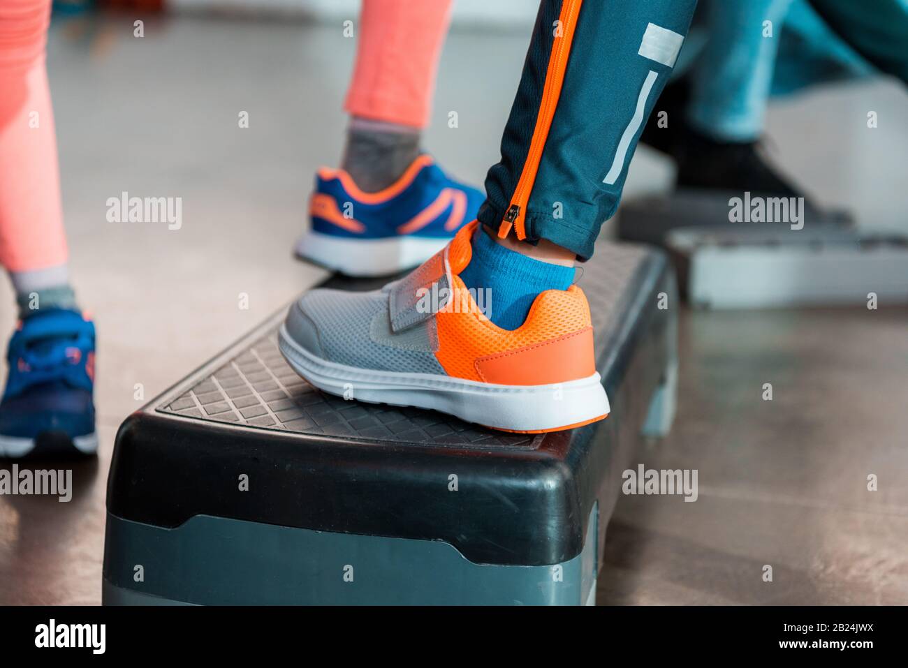 Cropped view of kids working out on step platform in gym Stock Photo ...