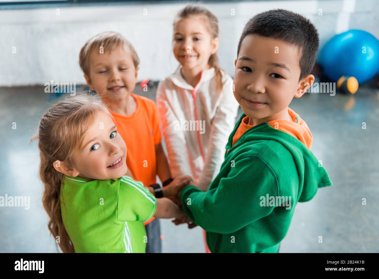 Selective focus of multicultural children standing together in circle ...
