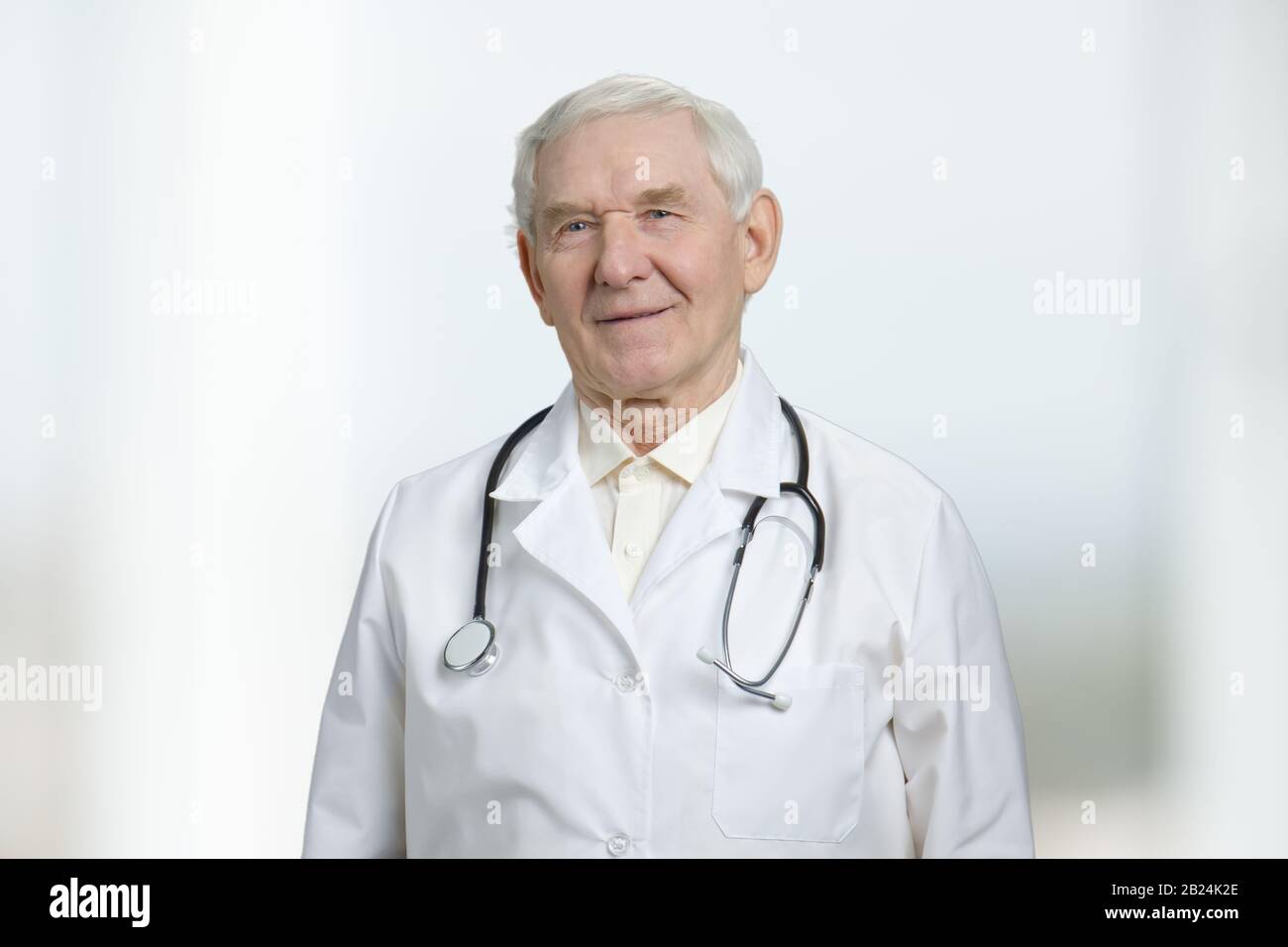 Old smiling caucasian doctor with stethoscope Stock Photo - Alamy