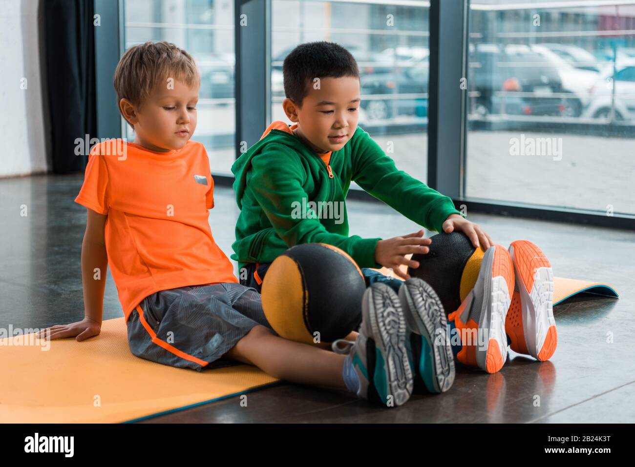 Kids sitting legs sneakers hi-res stock photography and images - Alamy