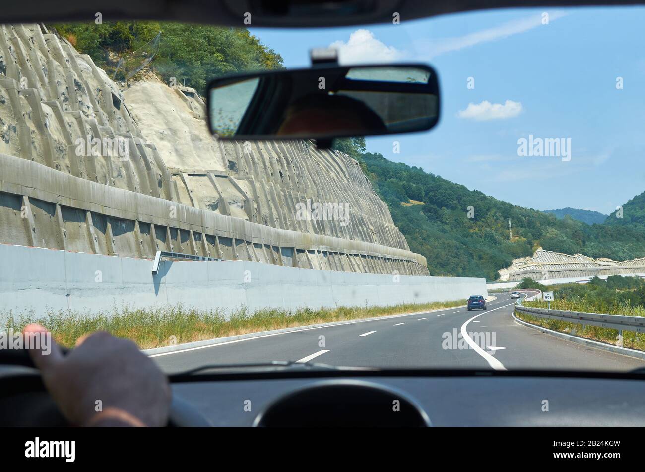 Driving a car on a asphalt highway through a gorge Stock Photo - Alamy
