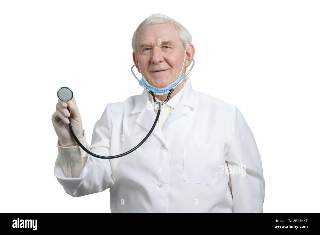 Old doctor with a stethoscope in the hands on white background Stock ...