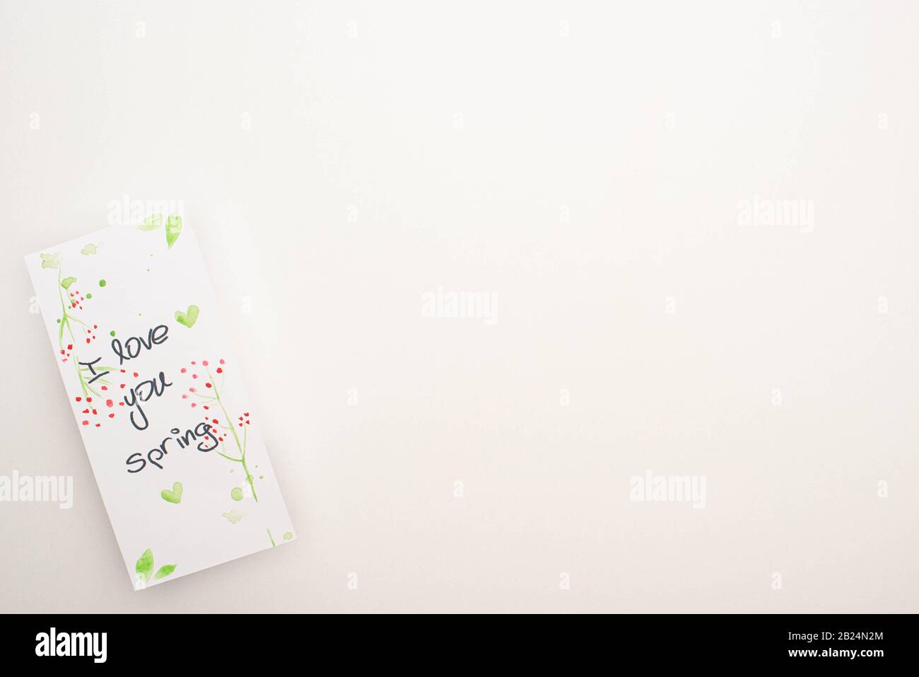 Top view of card with I love you spring lettering on white background ...