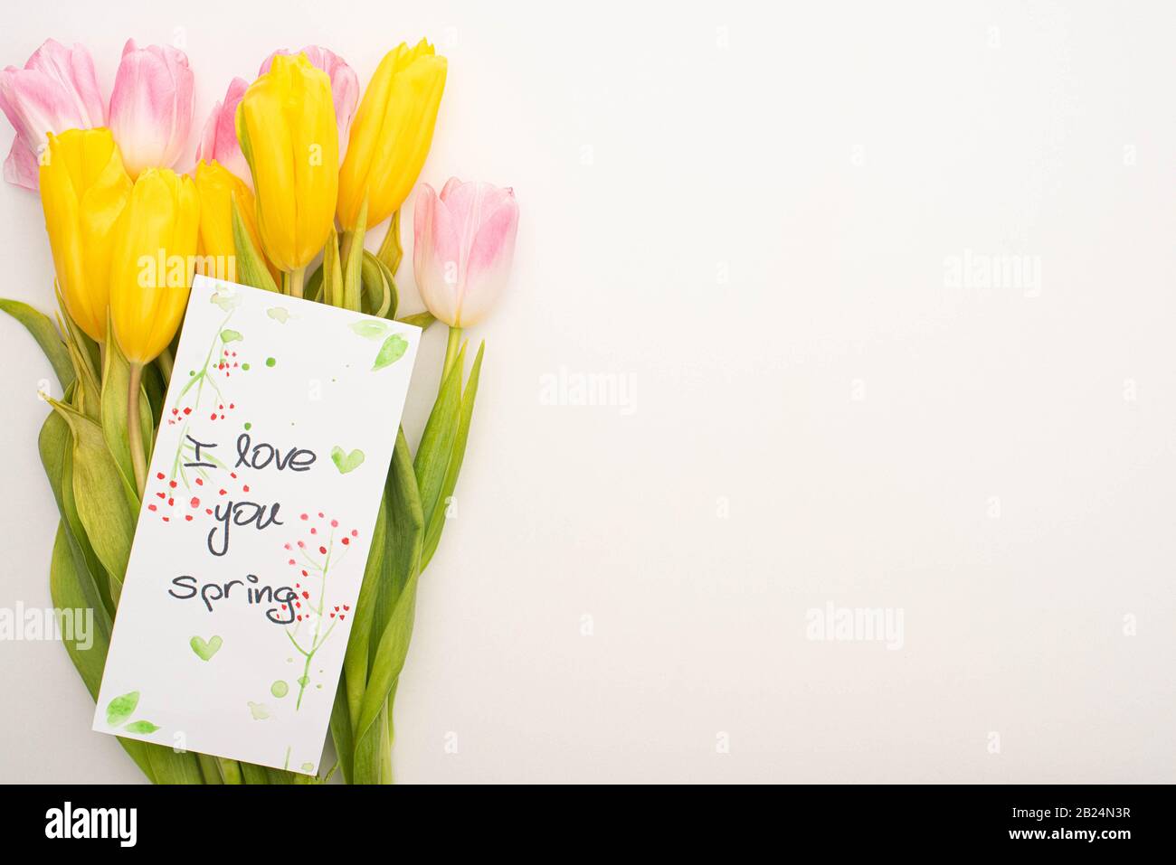 Top view of card with I love you spring lettering on bouquet of tulips ...