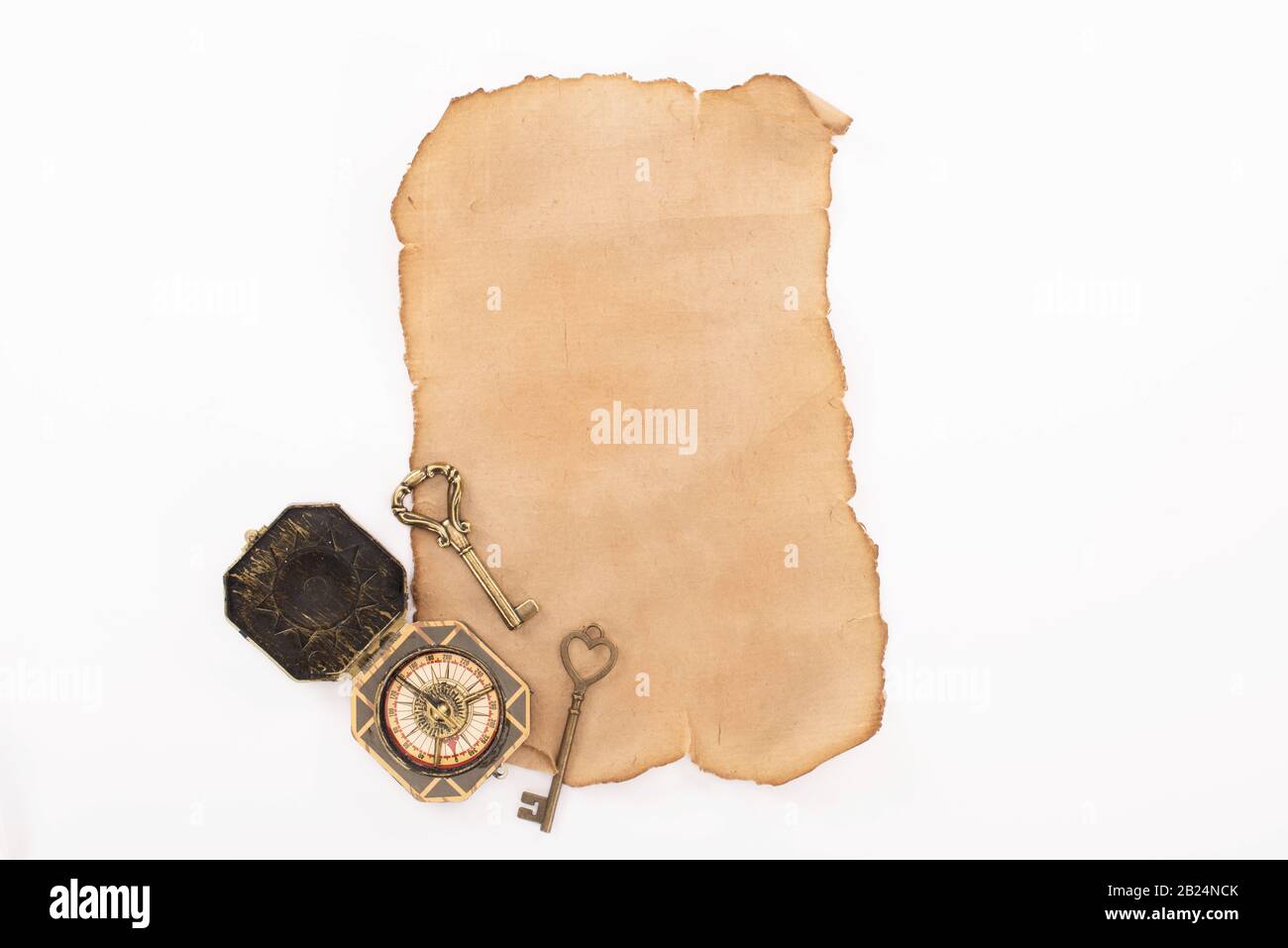top view of vintage compass, keys on aged paper isolated on white Stock ...