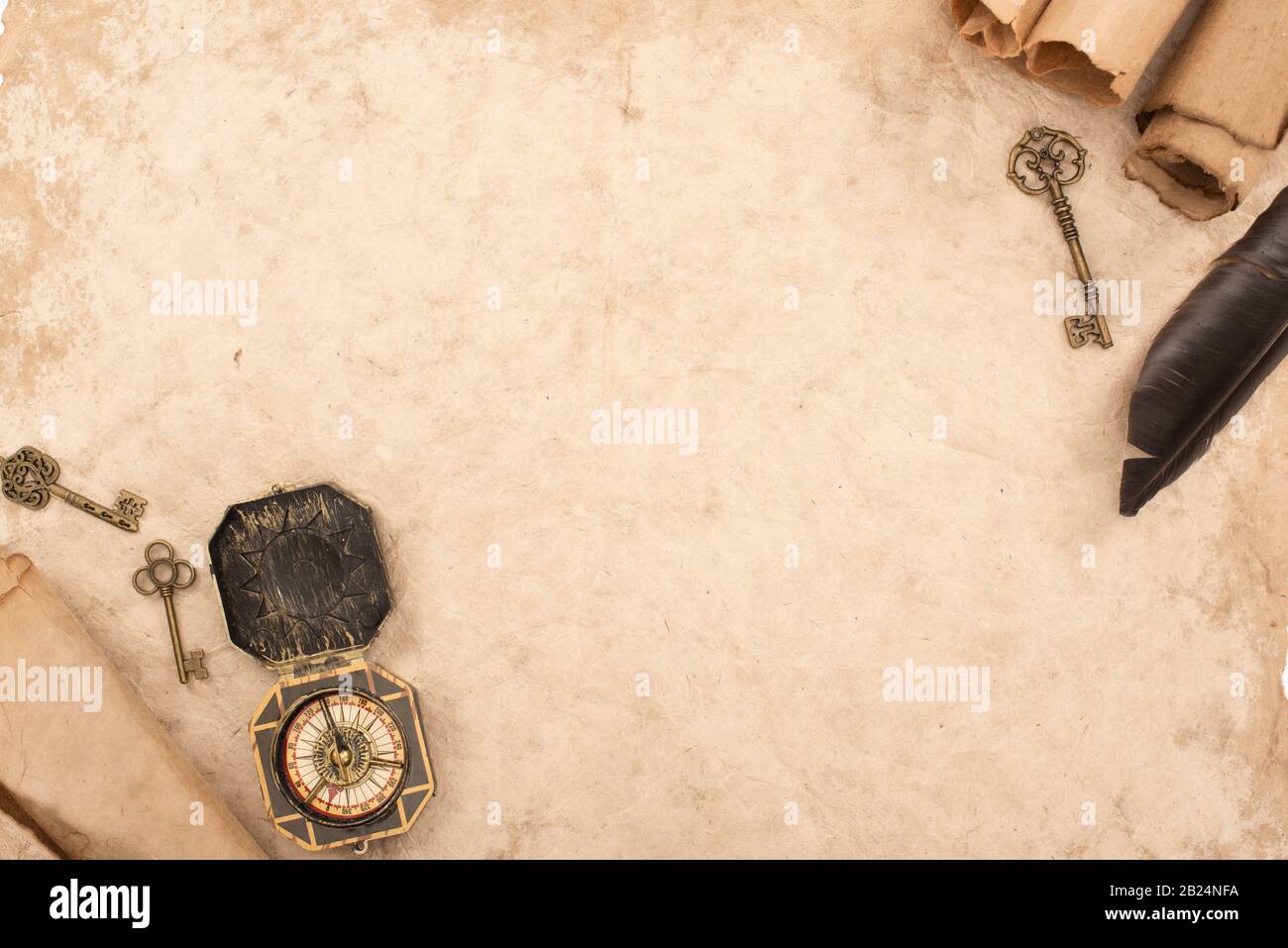 top view of feather, vintage keys and compass on aged paper Stock Photo ...
