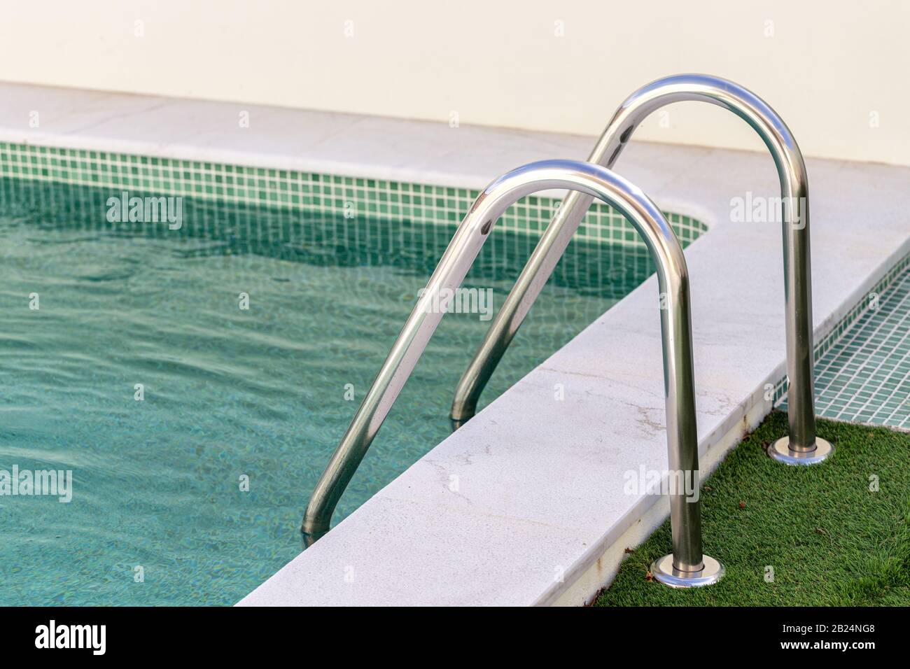 Inox railings in the pool on the grass Stock Photo - Alamy