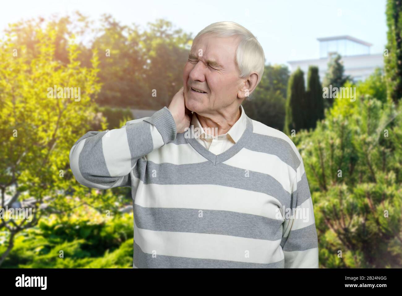 Old man with neck pain outdoor Stock Photo - Alamy