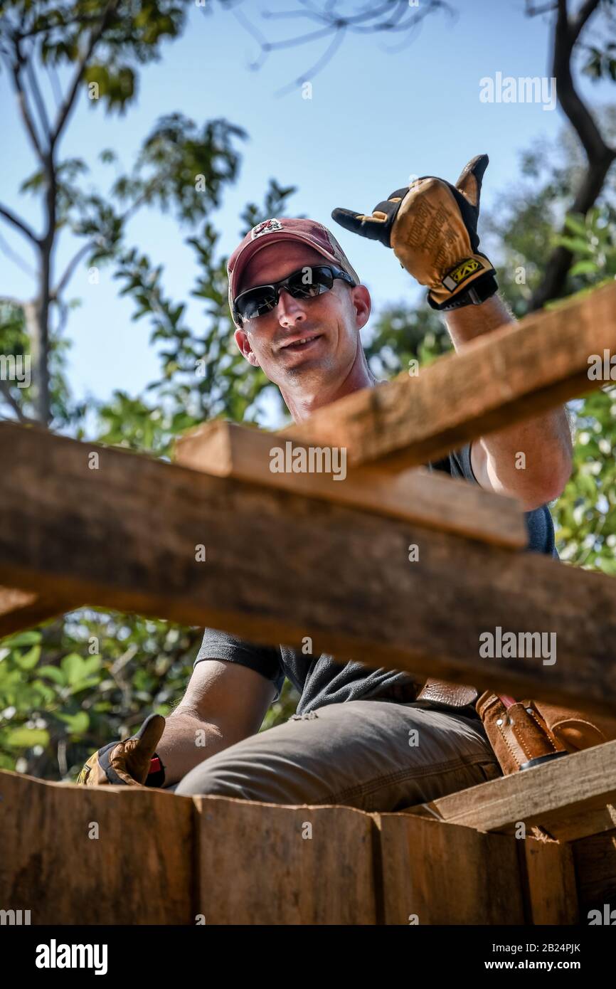 man working on house for poor family in Guatemalan village Stock Photo ...