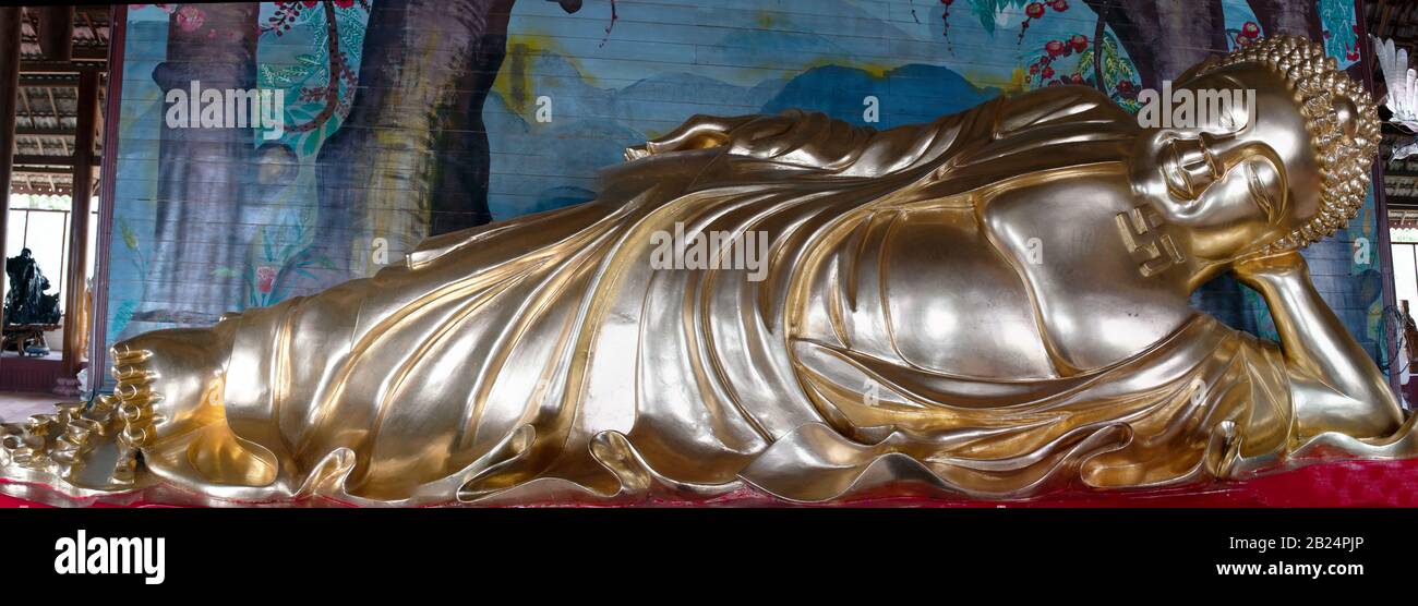 The sleeping wooden buddha in Dalat, Vietna. Lying Buddha in Temple. Golden statue of buddha lay ...