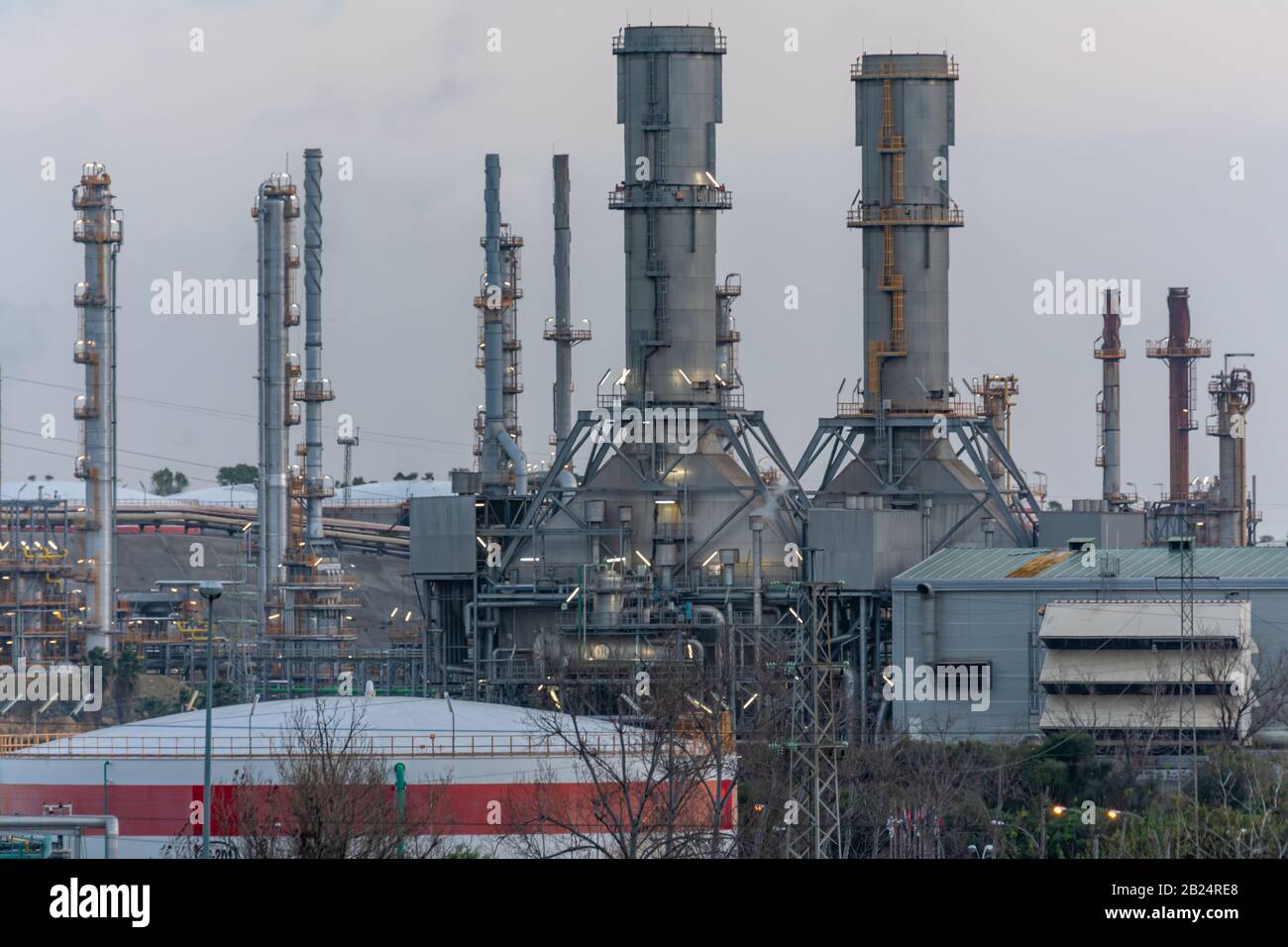 Landscape of a refinery, with refining towers and smoking chimneys ...