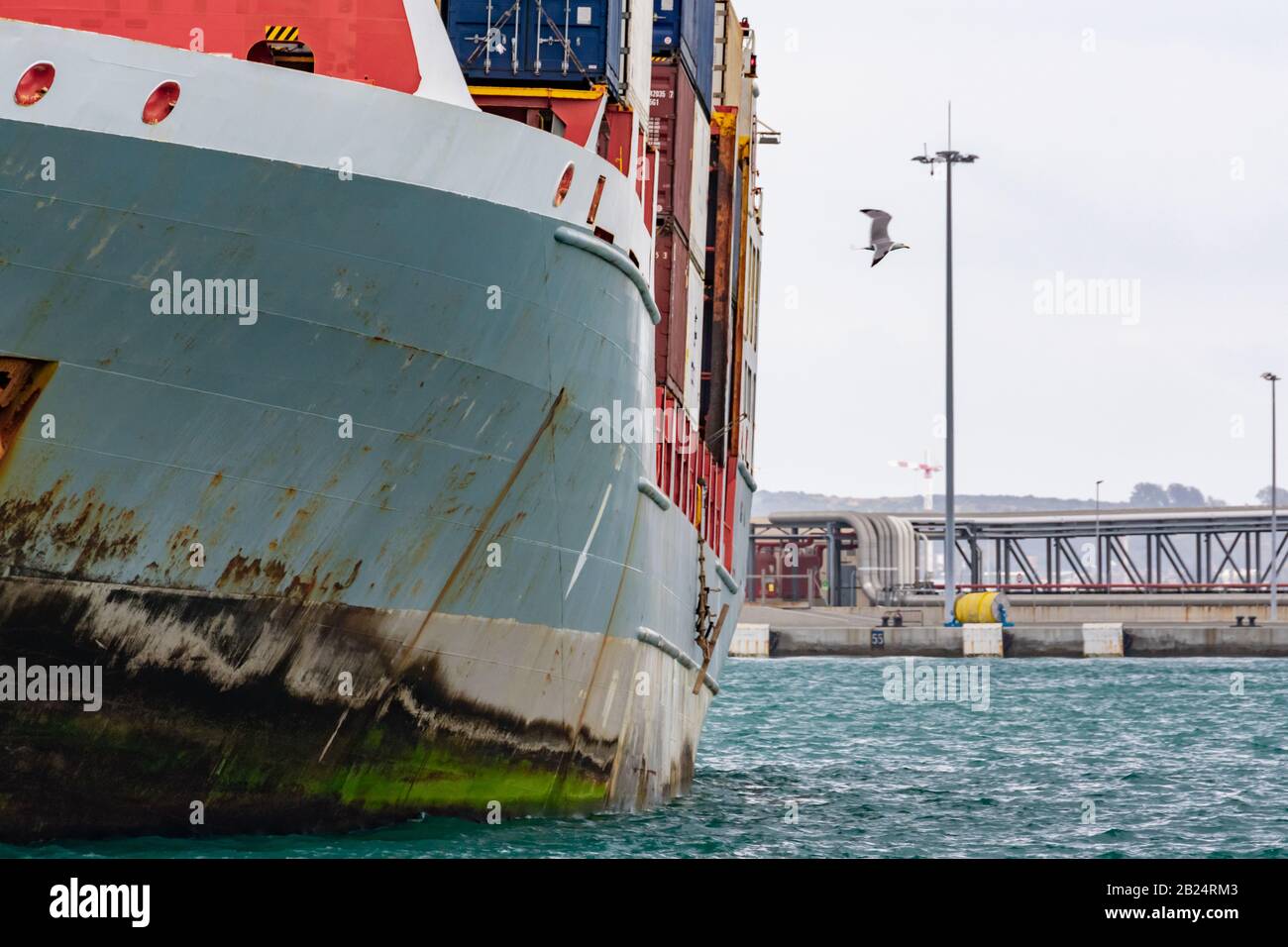 Side view of a container ship moored in the harbor Stock Photo - Alamy