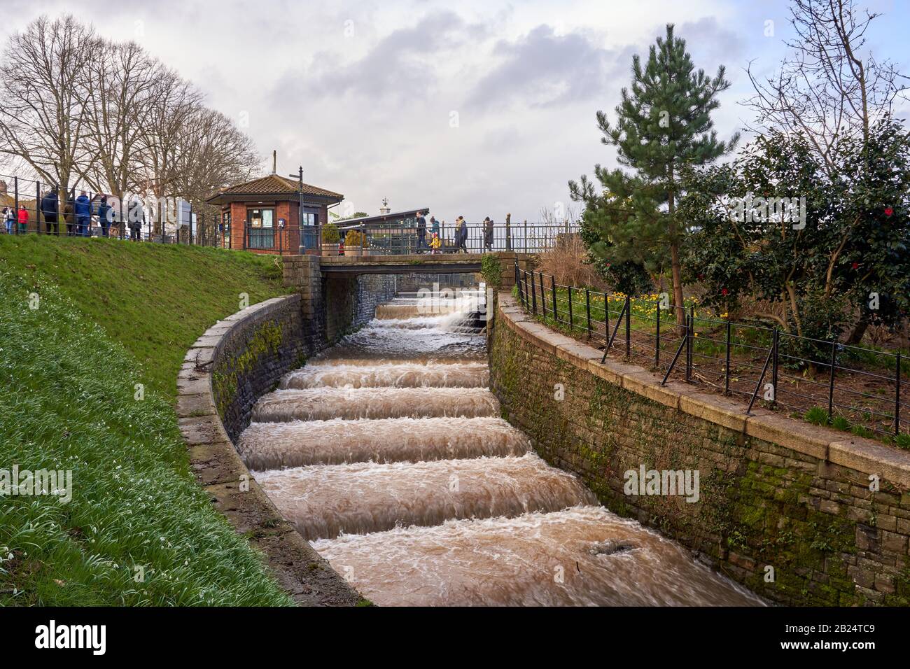 A large volume of water flowing down the overflow channel after several ...