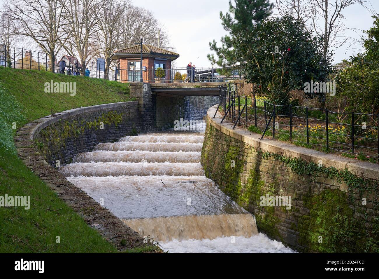 A large volume of water flowing down the overflow channel after several ...