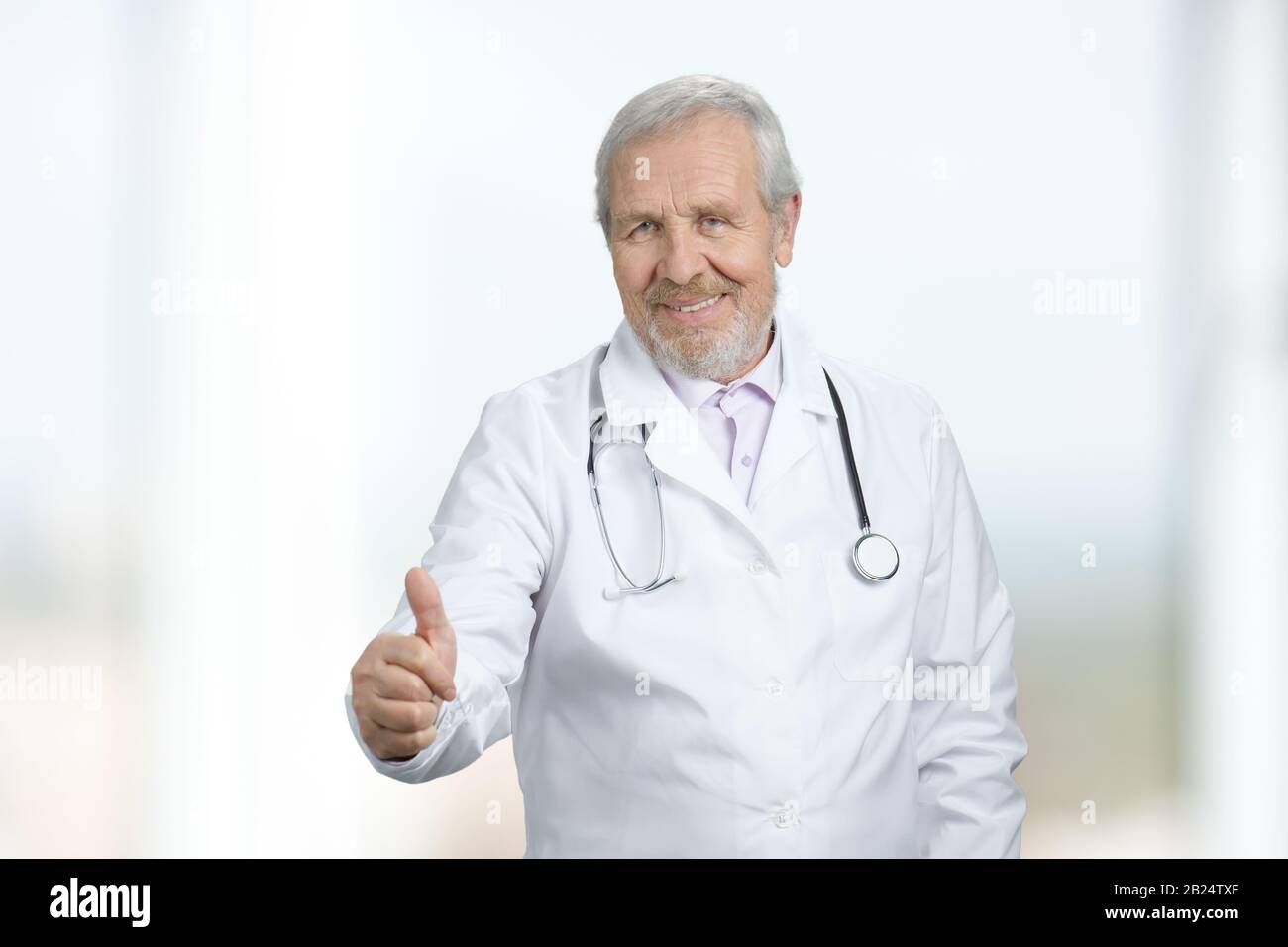 Old wrinkled doctor with like sign gesture Stock Photo - Alamy