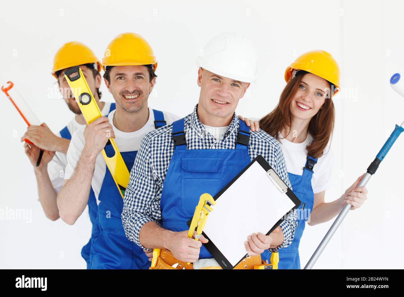 Team of happy smiling workers with tools and contract isolated on white ...