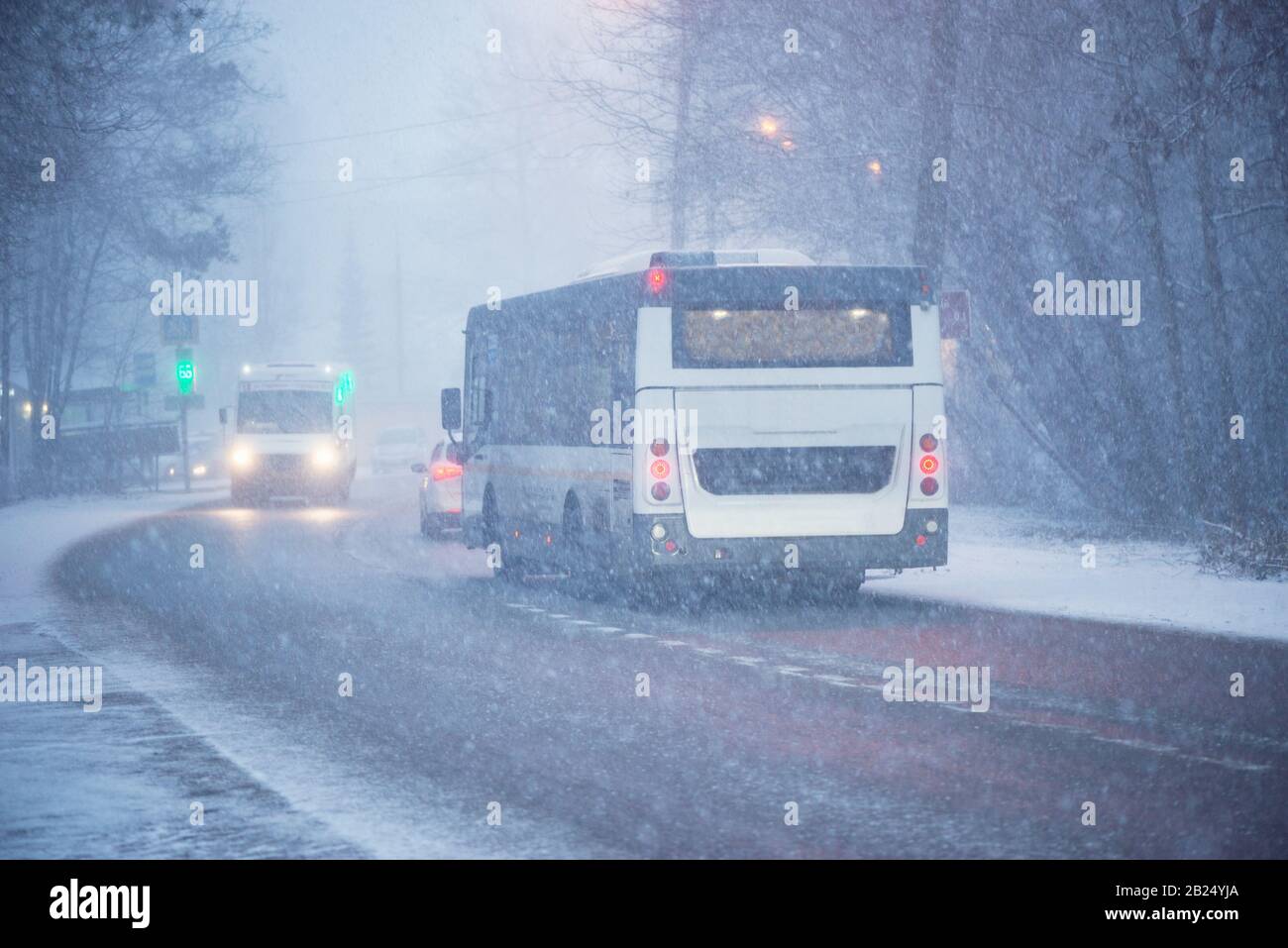 Buses move on the road at winter evening time Stock Photo - Alamy