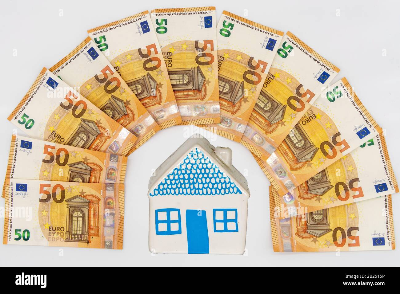 Model of a little house and an arch of banknotes, representing the ...