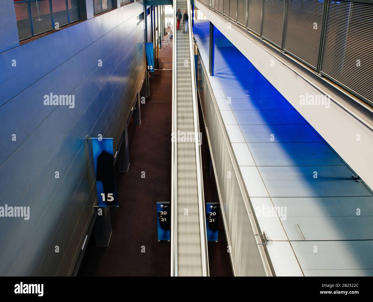 View of people silhouettes ascending on the fast escalators inside ...