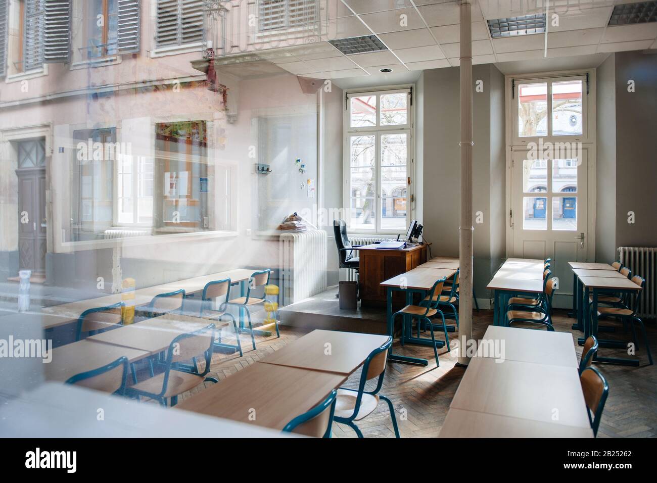 View from the street of large school classroom with empty seats ...