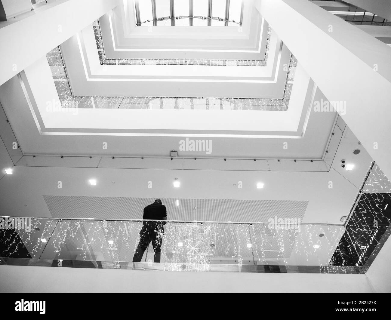 Low angle view of black ethnicity guard security male in tall shopping ...