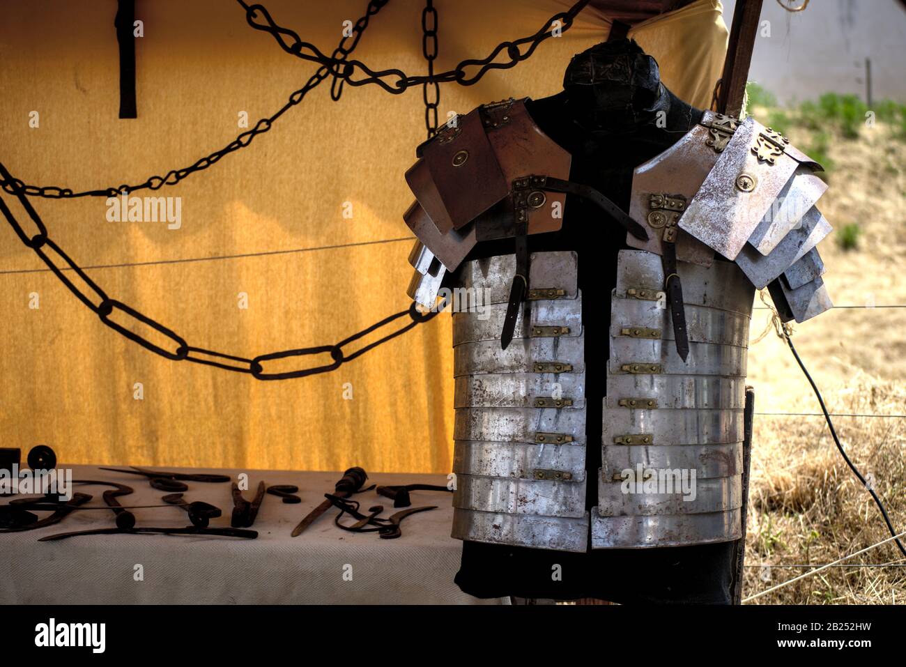 Traditional roman lorica segmentata inside a yellow tent with metal ...