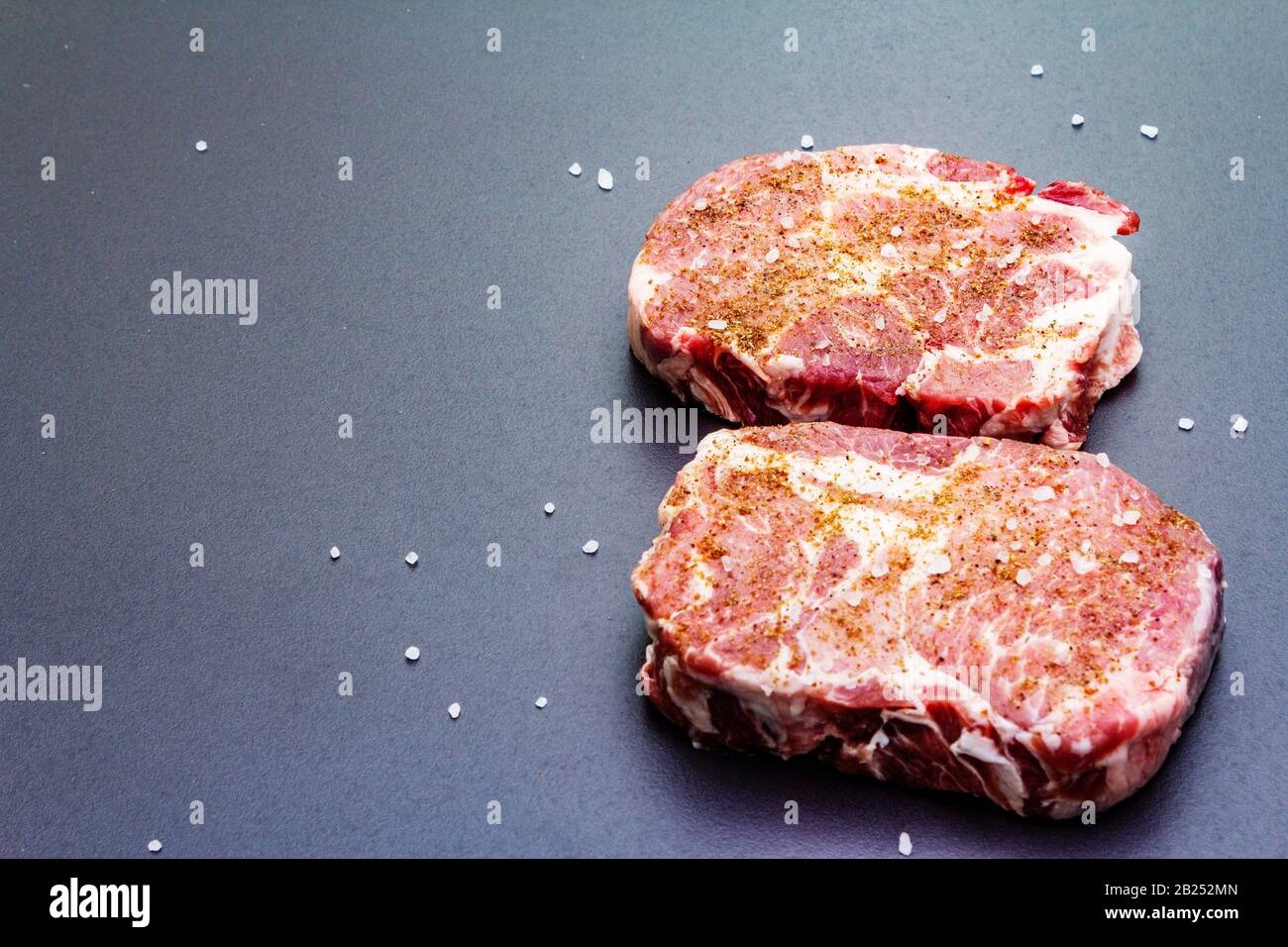 Organic raw pork steak, marinated in dry spices, with sea salt. Cooking ...