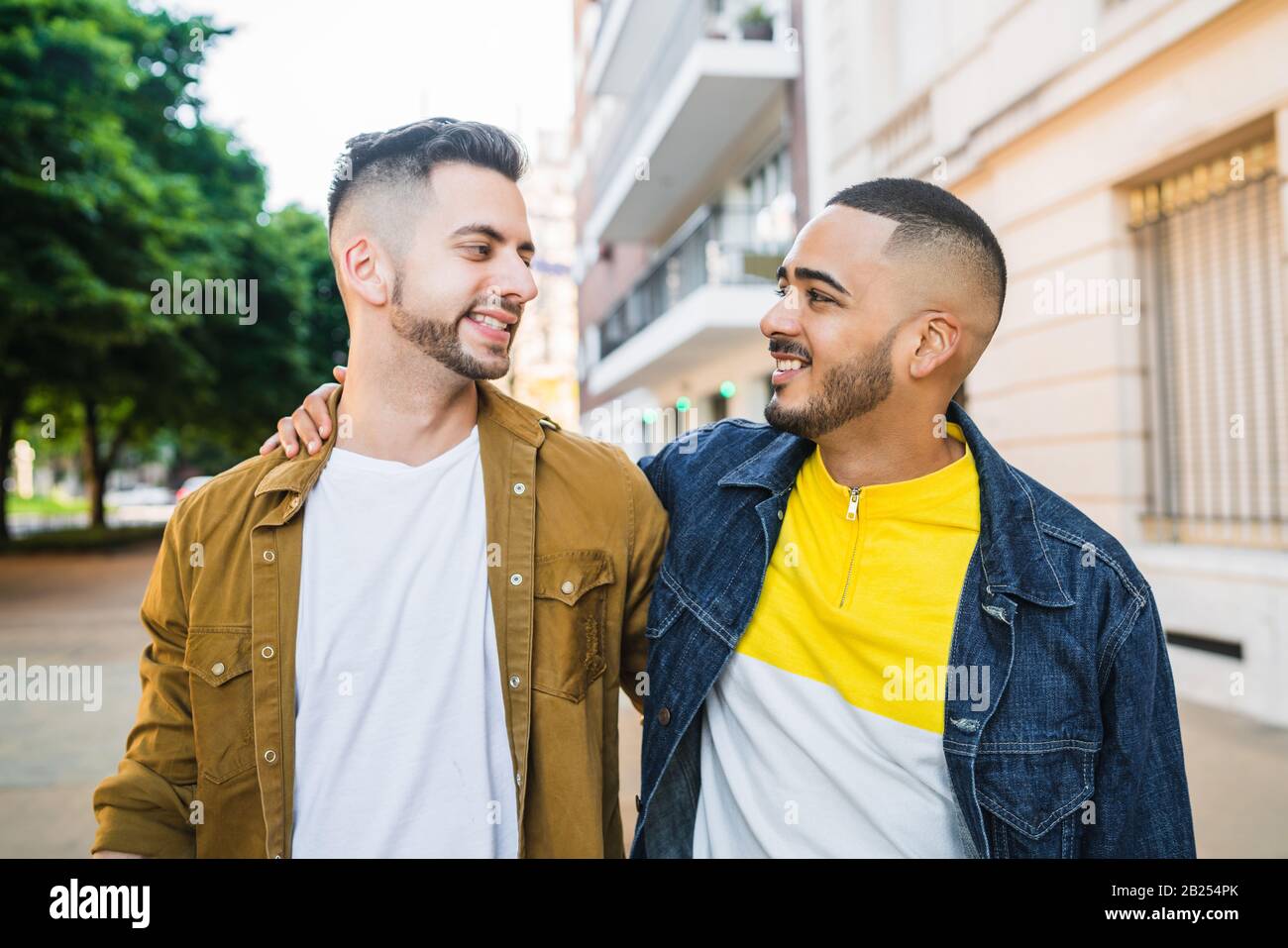 Portrait Of Happy Gay Couple Spending Time Together While Walking In