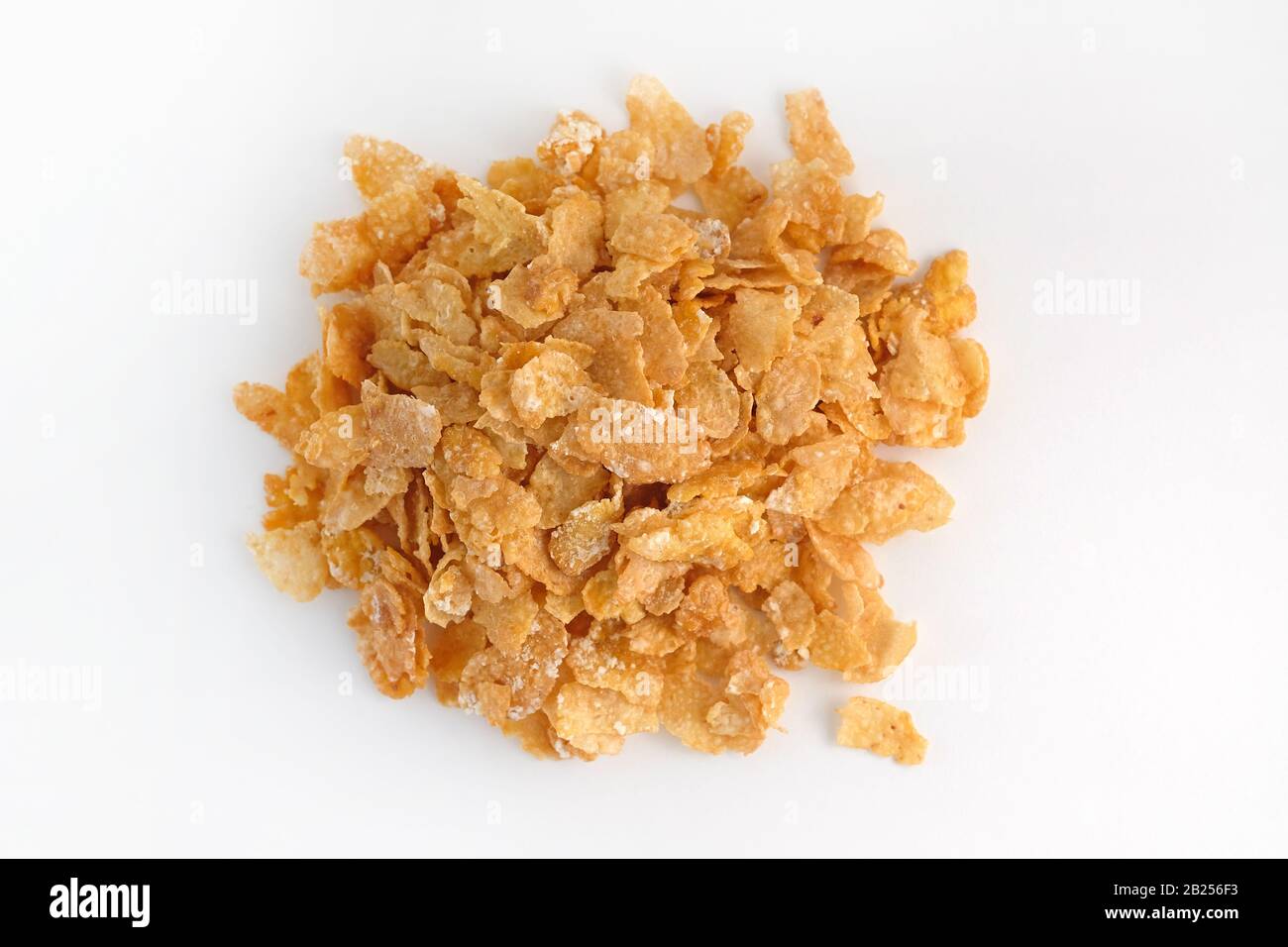 Dry corn flakes top view. Thin cornflakes in glaze on a white ...
