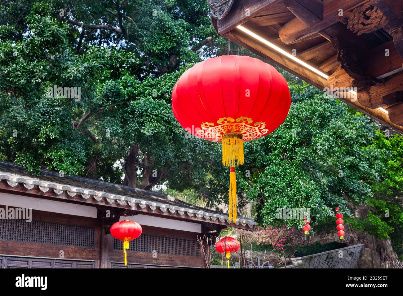 Beautiful red Chinese lantern hanging on eaves of traditional Chinese ...