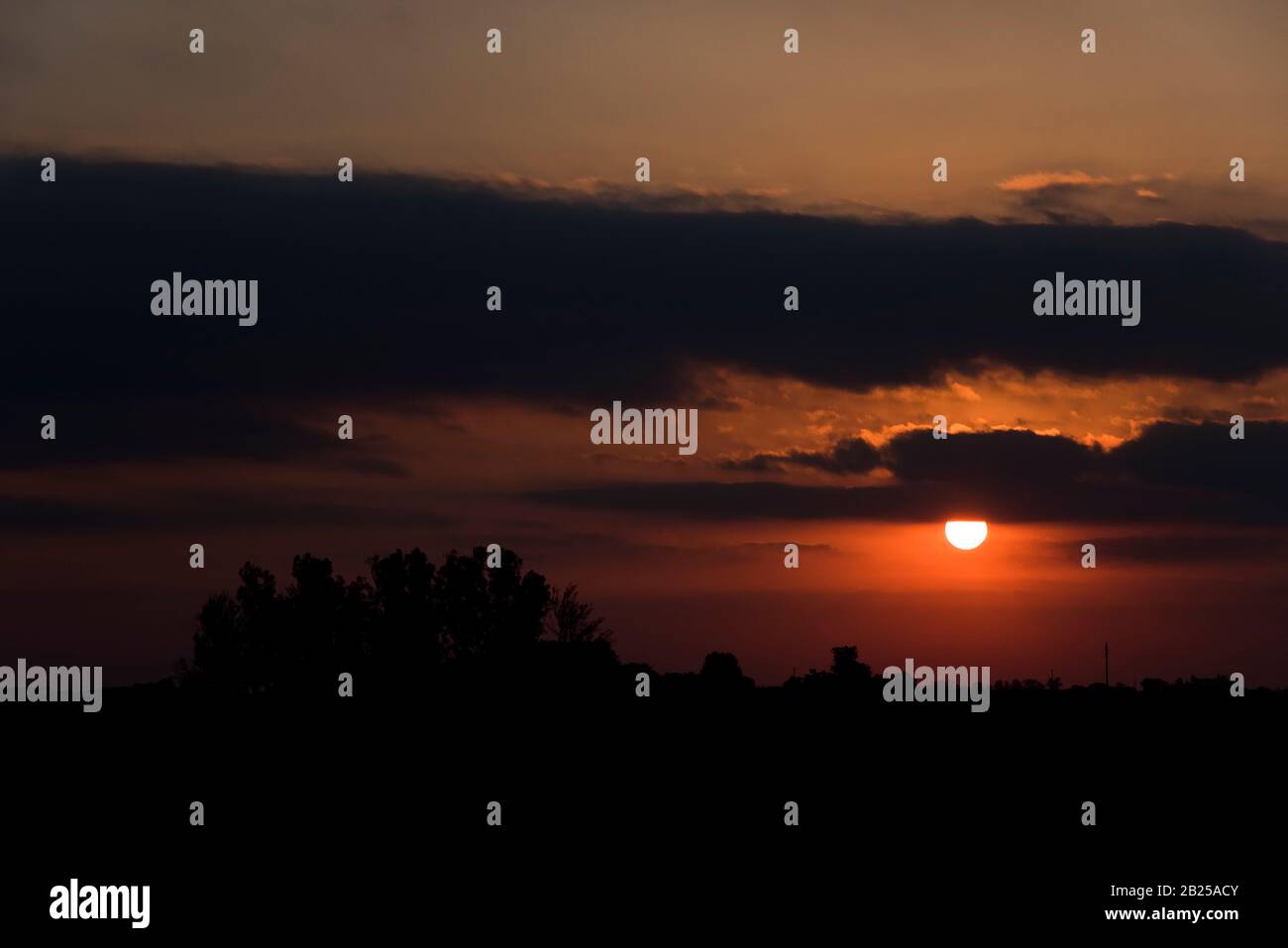 Dramatic and beautiful sunset, cloudy sky with parts of intense orange ...