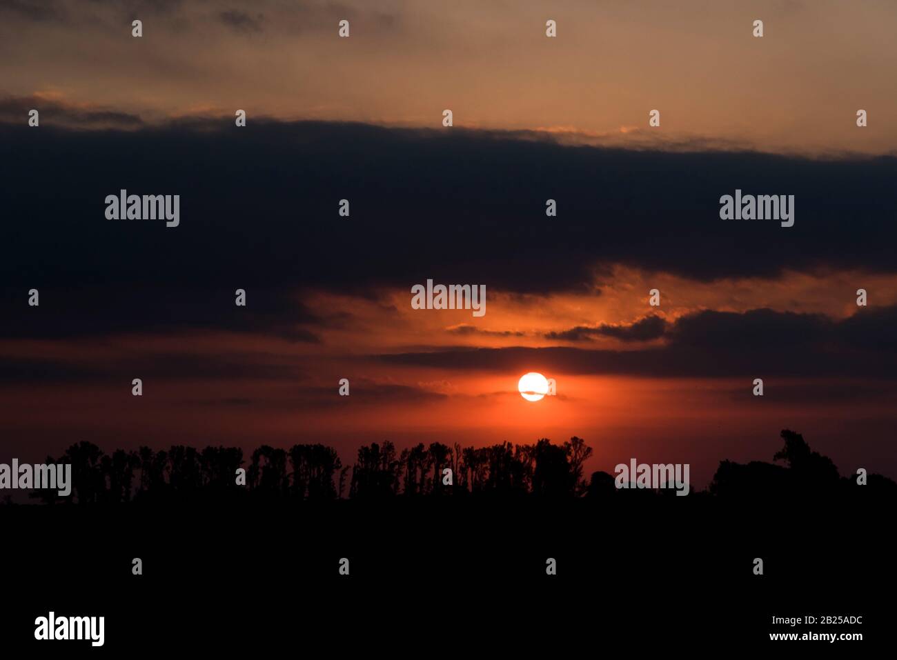Dramatic and beautiful sunset, cloudy sky with parts of intense orange ...