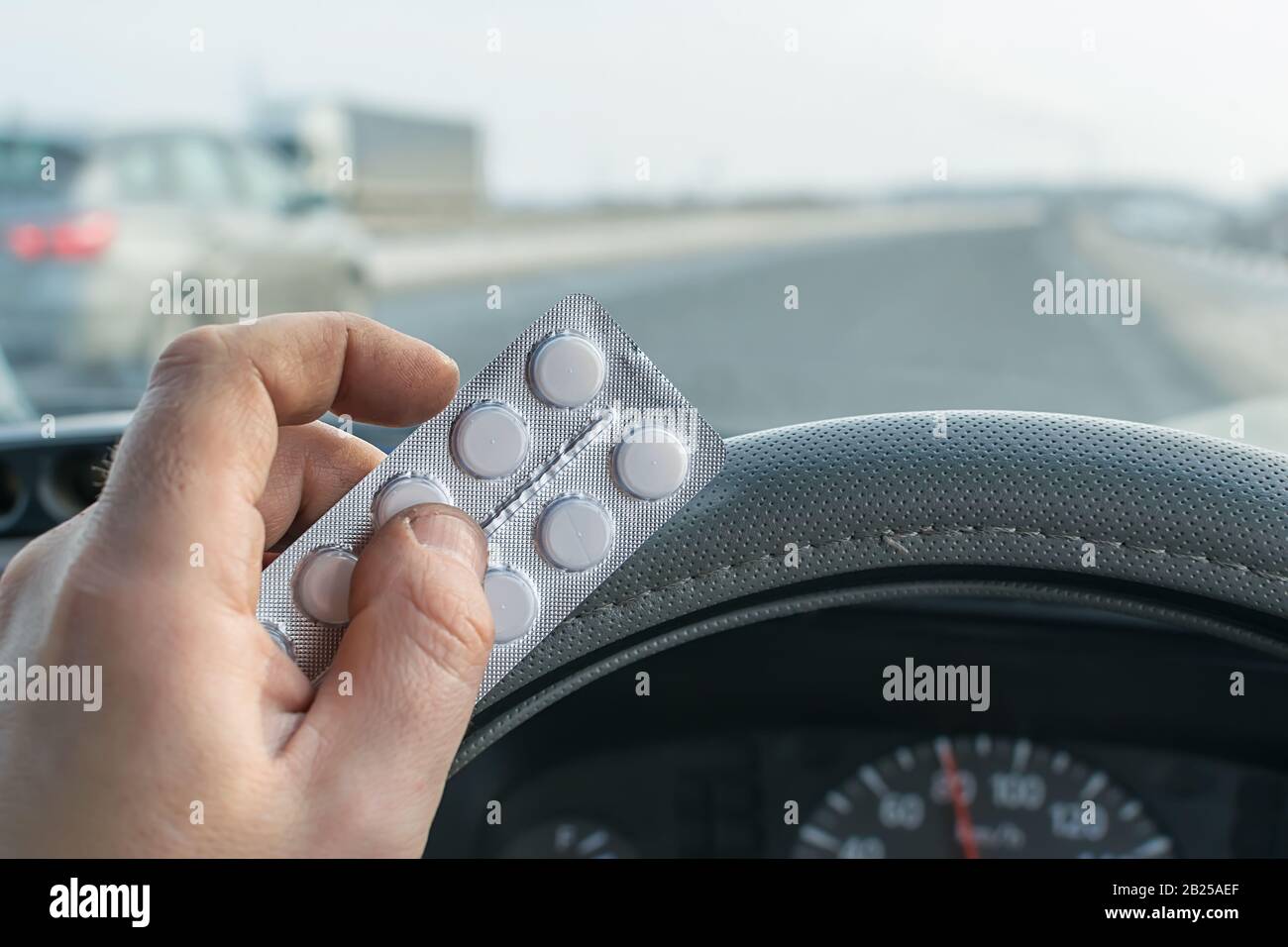 driver hand holding a bag of pills while driving on the highway Stock ...