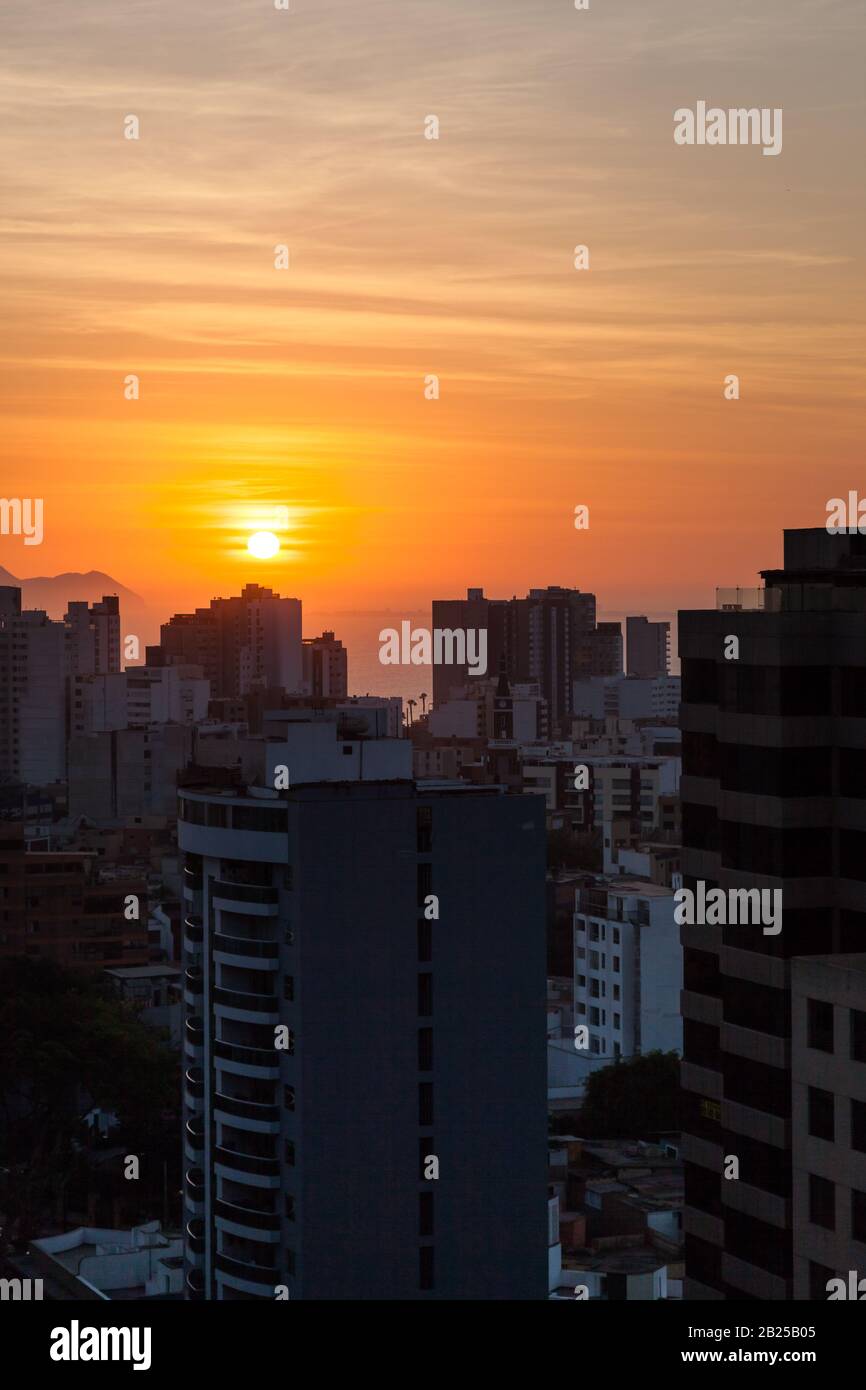 LIMA / PERU - May 10 2016: A rooftop view of the skyscrapers and sunset ...