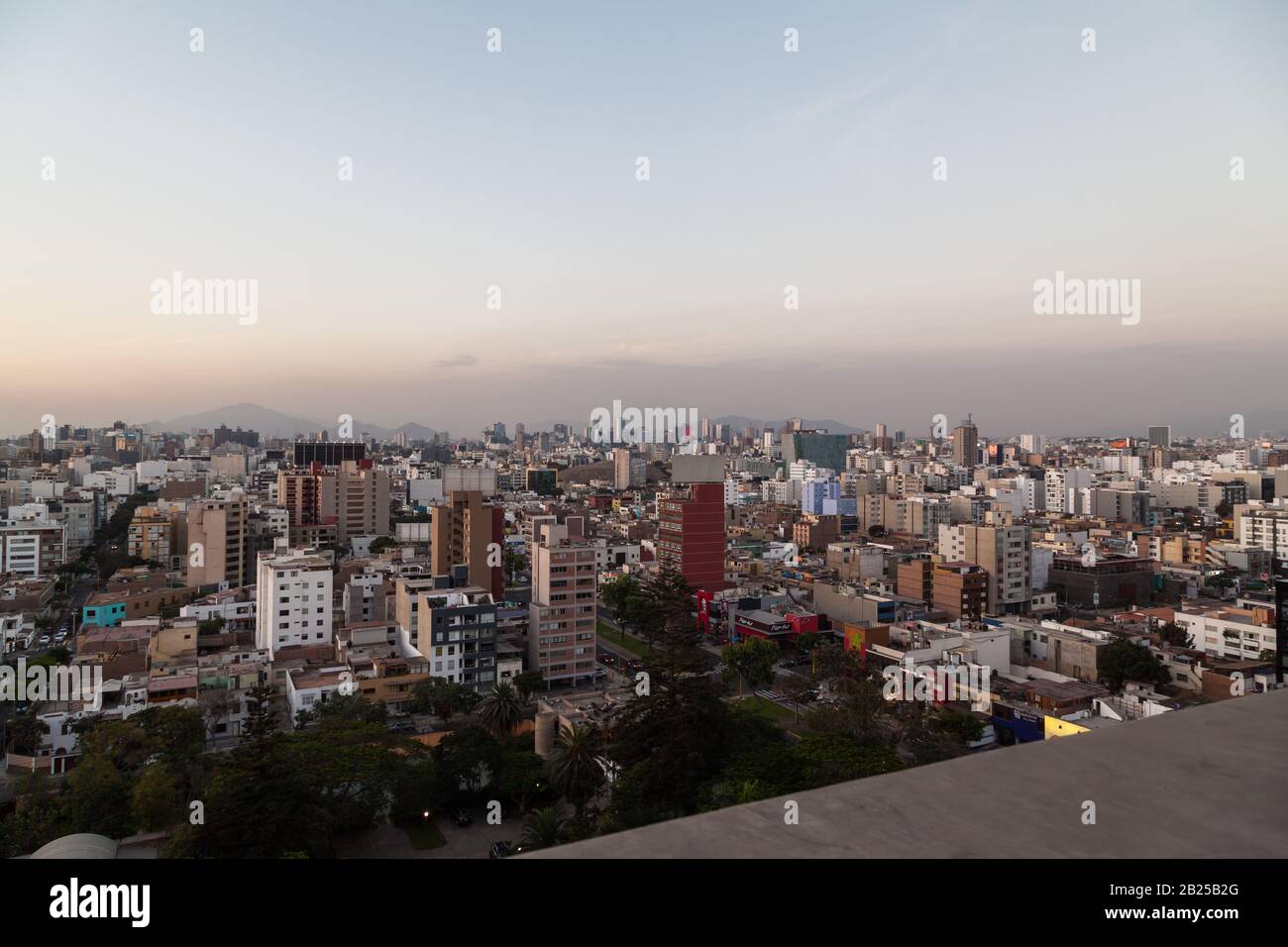 LIMA / PERU - May 10 2016: A rooftop view of the skyscrapers and sunset ...