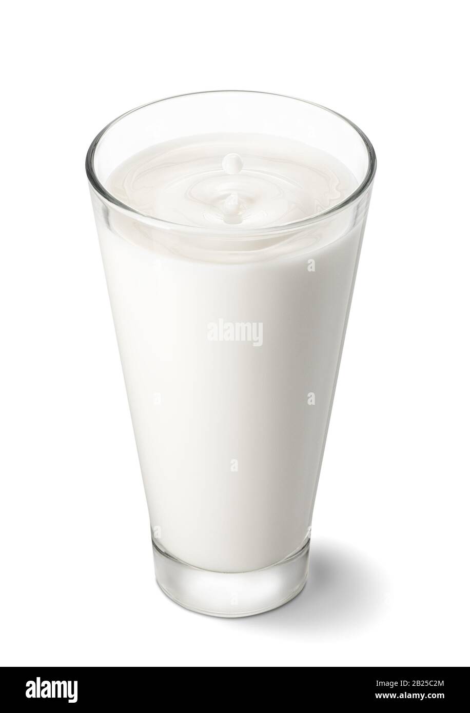 drop falling in glass of milk and created splash with circle ripple ...