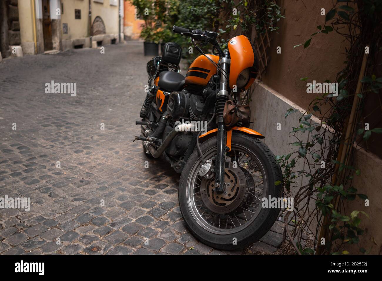 Motorcycle parked on a side street in Rome Stock Photo - Alamy