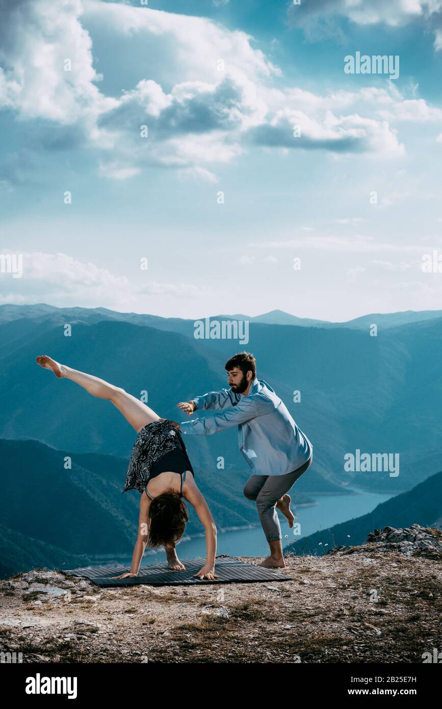 Romantic young loving couple dancing outdoors under blue sky at ...