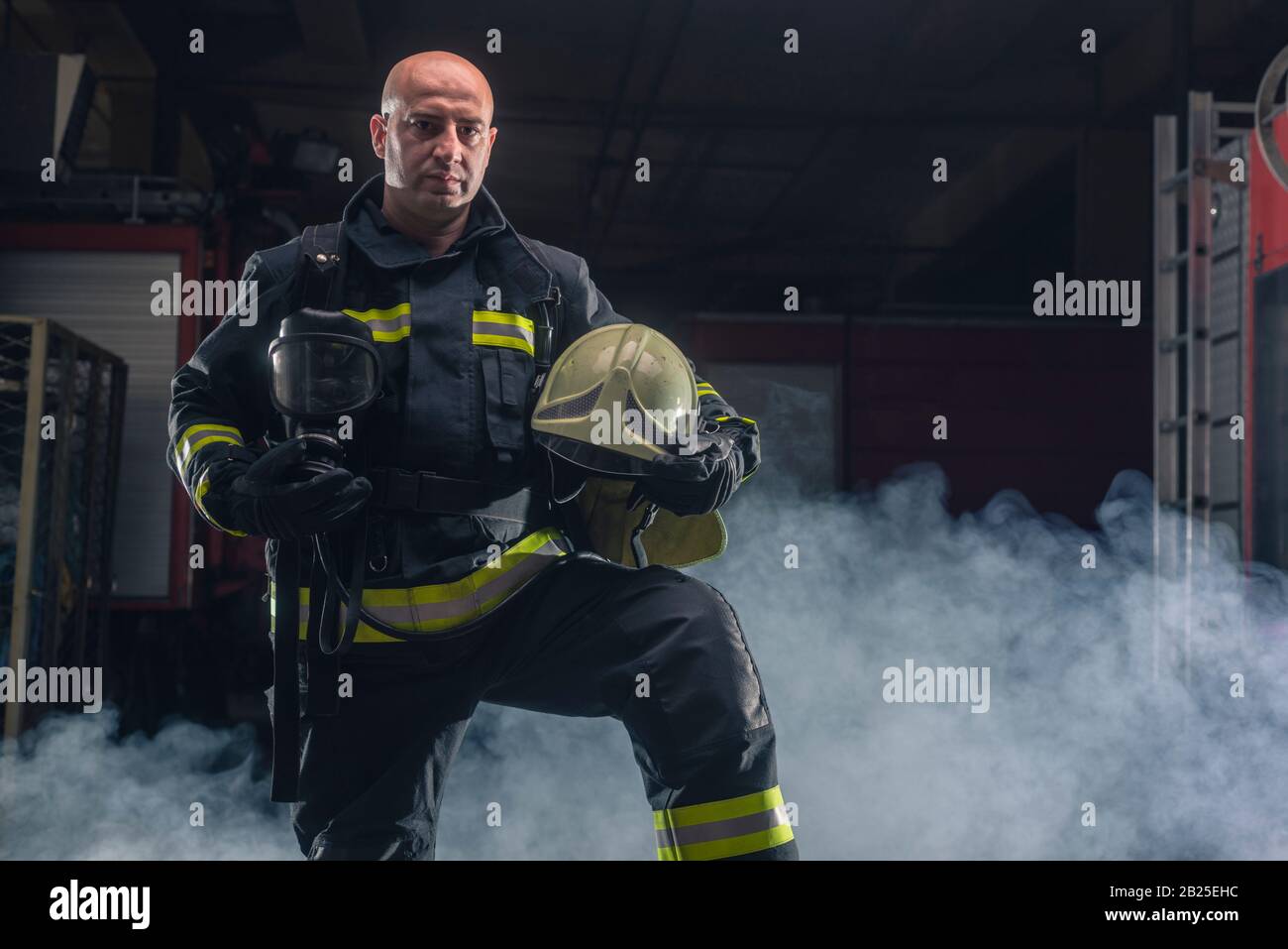 Fireman standing confident holding helmet and wearing firefighter ...