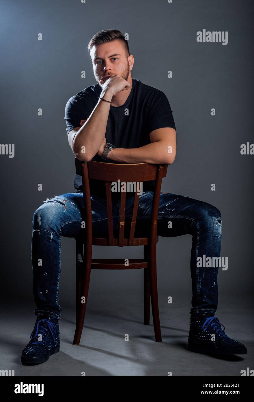 Portrait of a handsome stylish man posing in trendy modern clothing ...