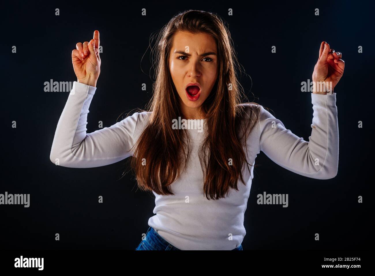 Beautiful angry brown-haired angry girl accusing everyone isolated over ...