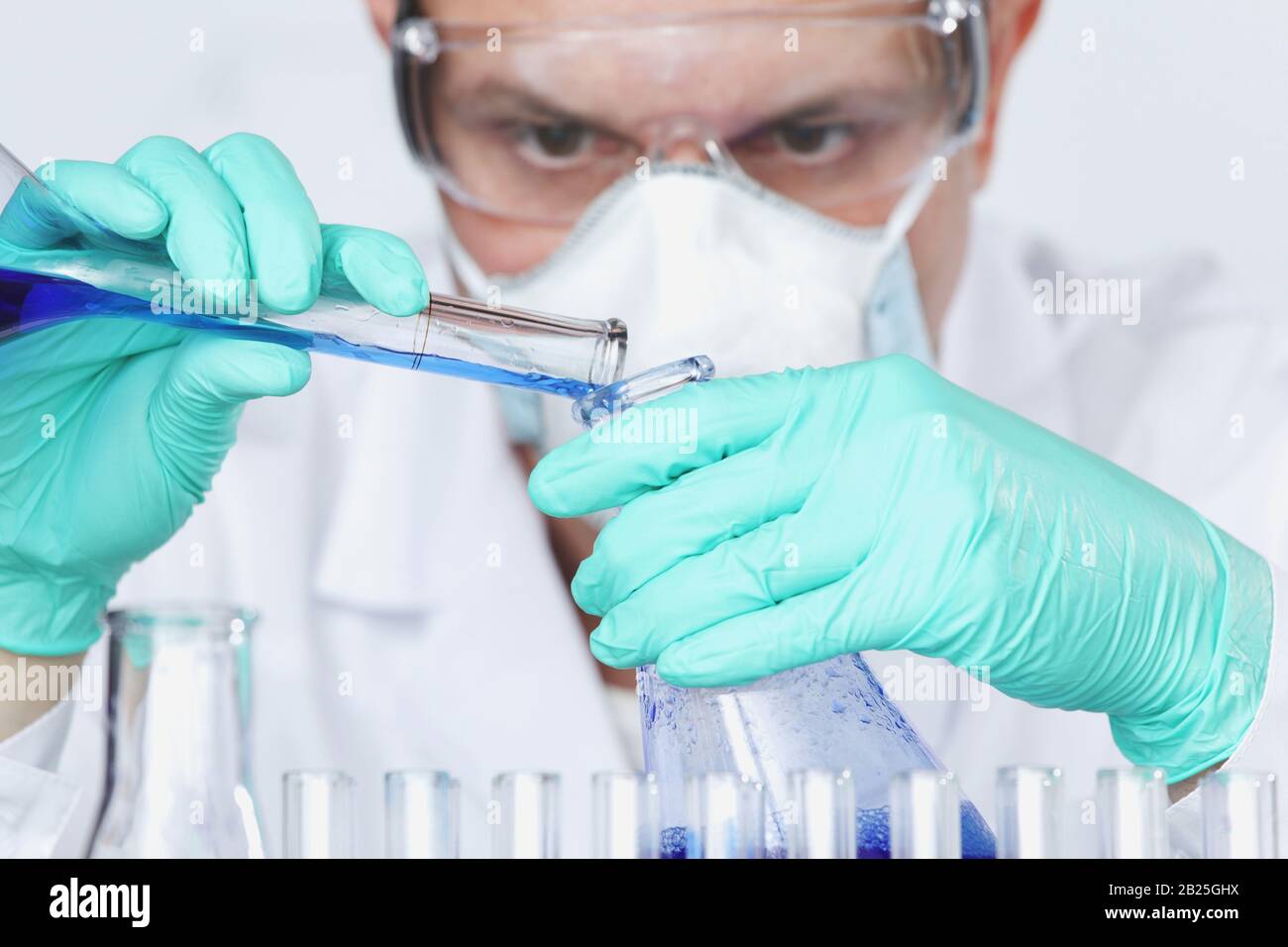 Mature researcher carrying out experiment hi-res stock photography and ...
