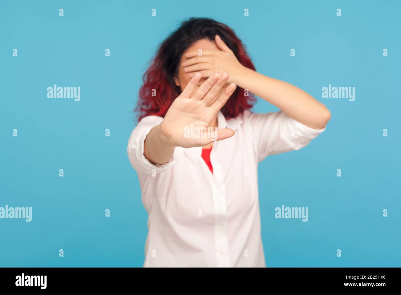 Portrait of embarrassed woman showing stop gesture, covering eyes with ...